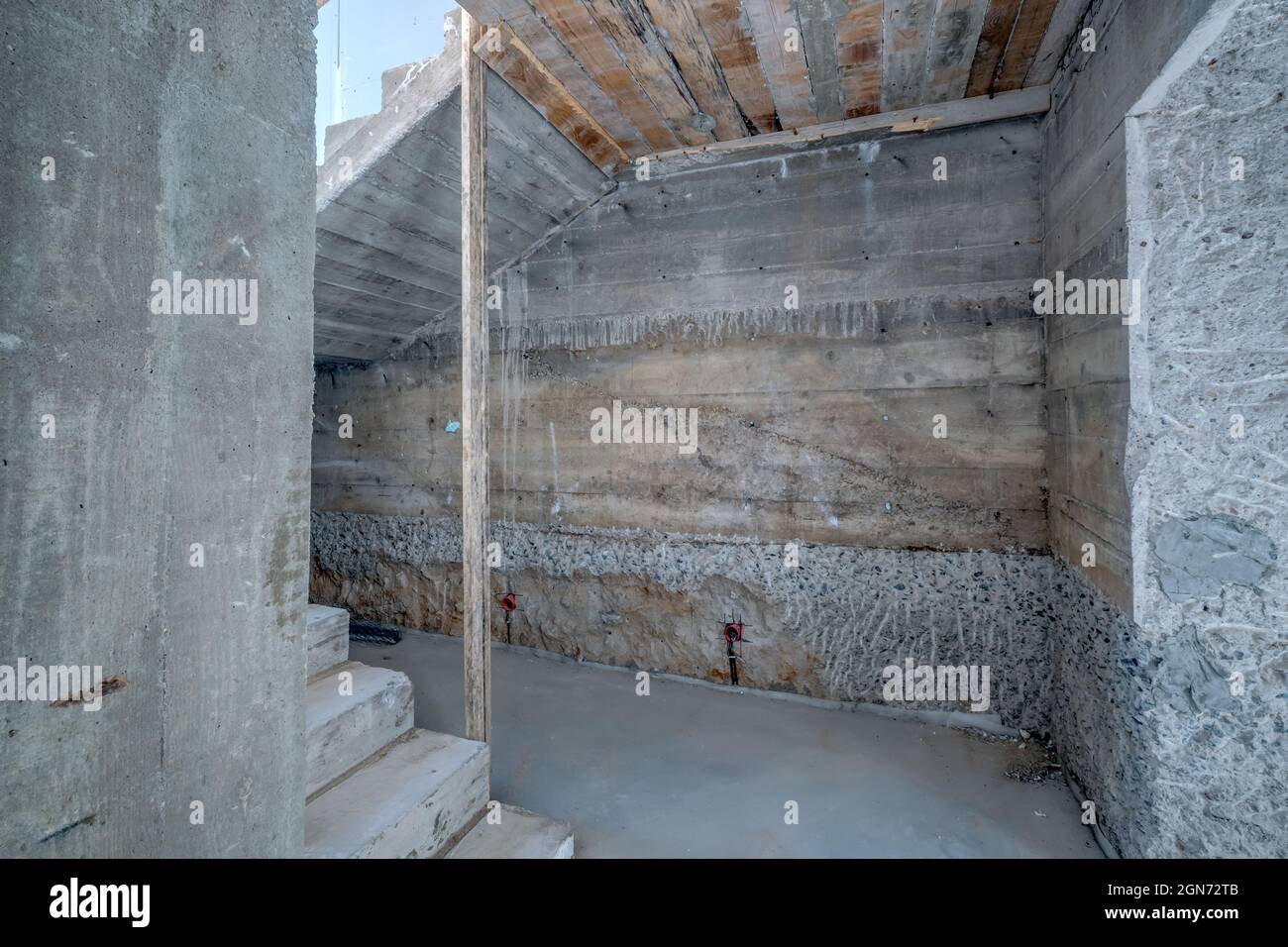 Empty basement room with minimal preparatory repairs in interior with ...