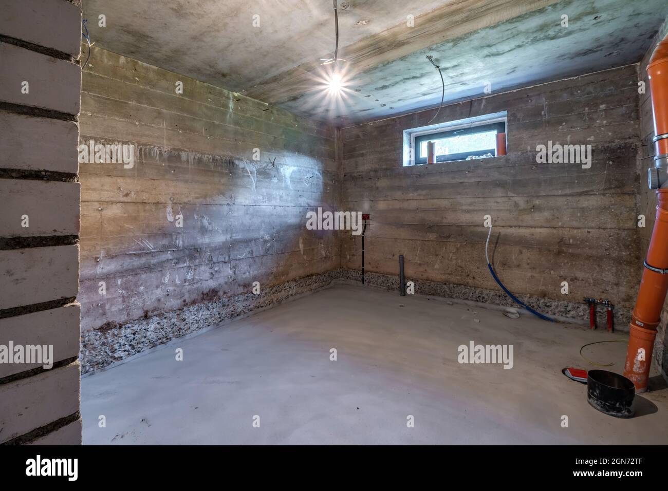 Empty basement room with minimal preparatory repairs in interior with ...