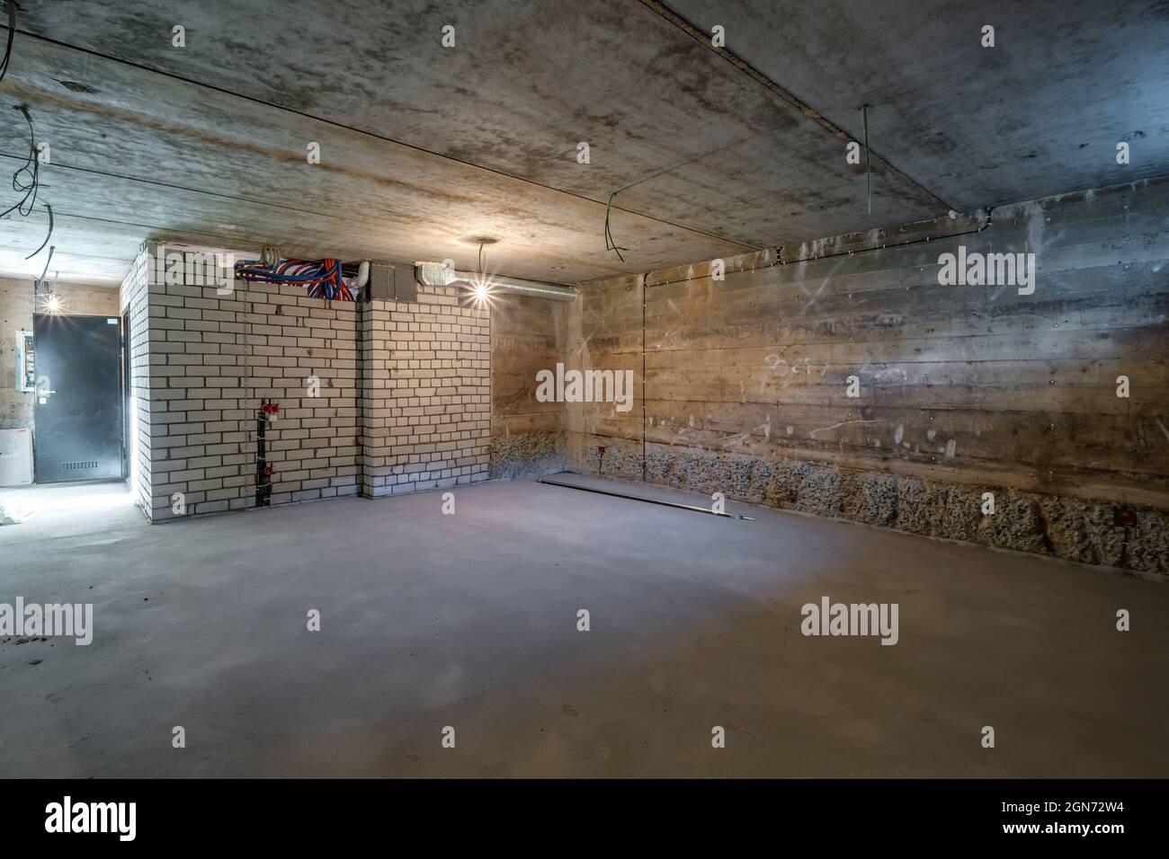 Empty basement room with minimal preparatory repairs in interior with ...
