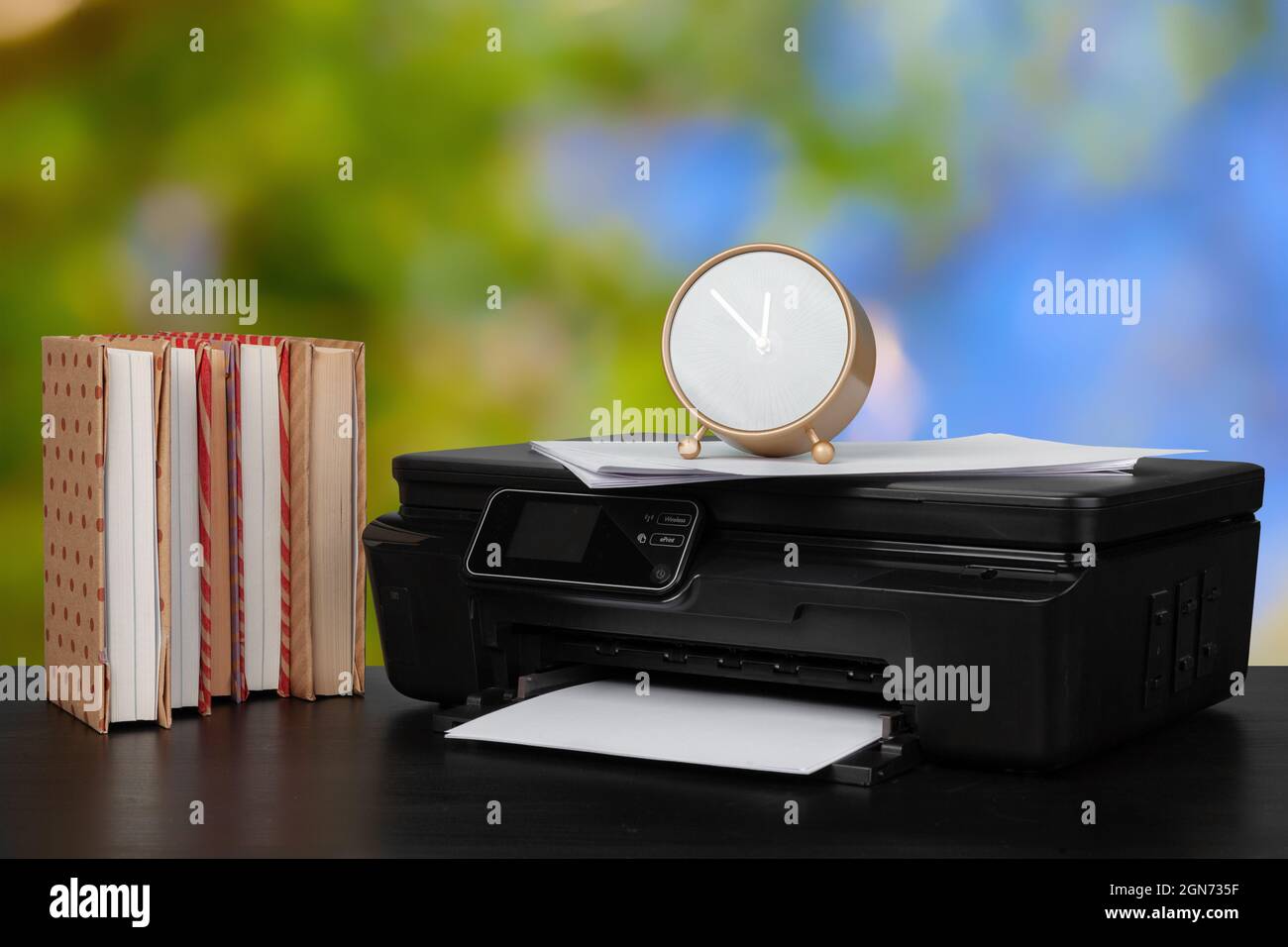 Stack of books and home printer against blurred background Stock Photo ...