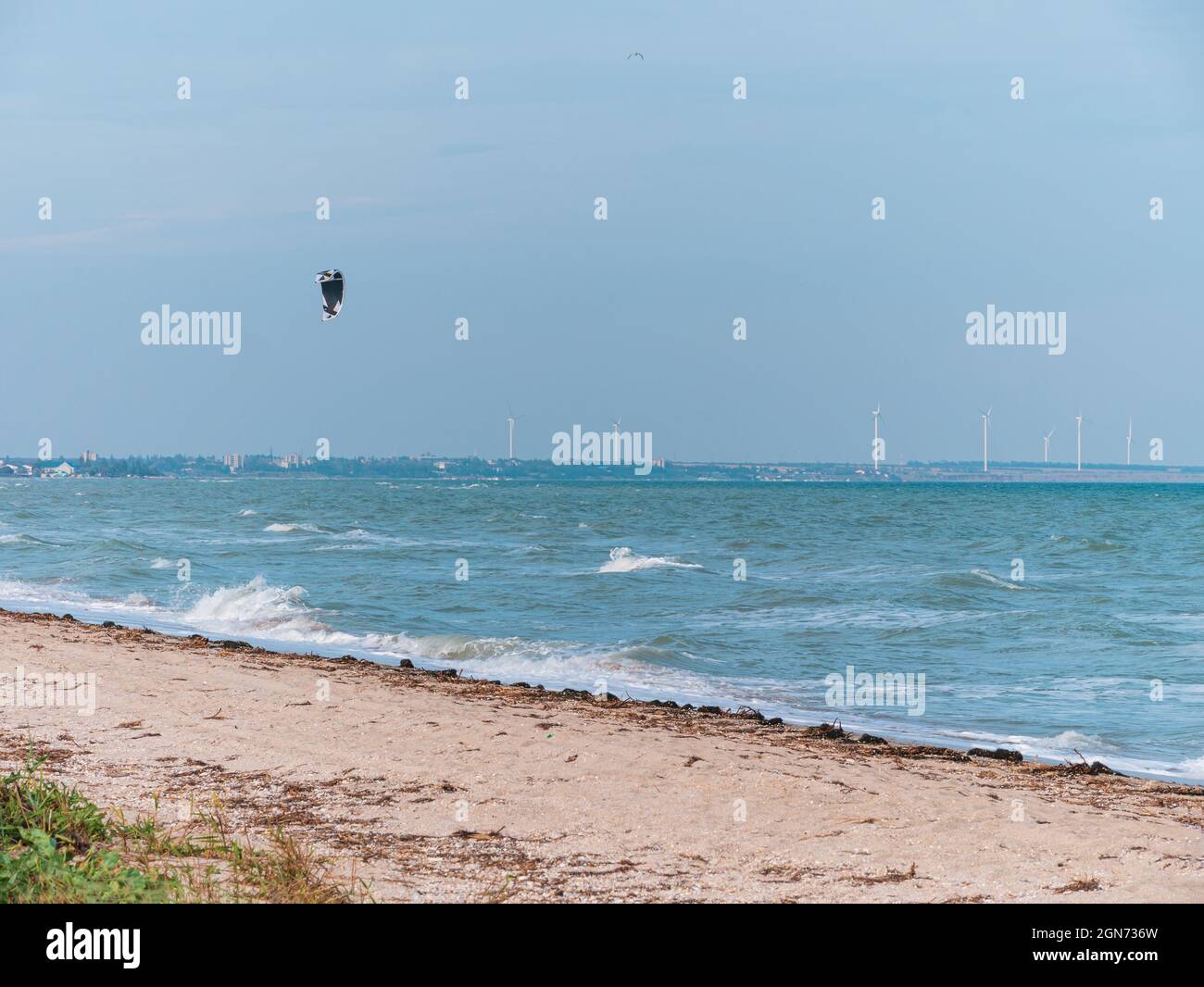 The athlete practices kite board surfing on blue sea waves. Autumn ...
