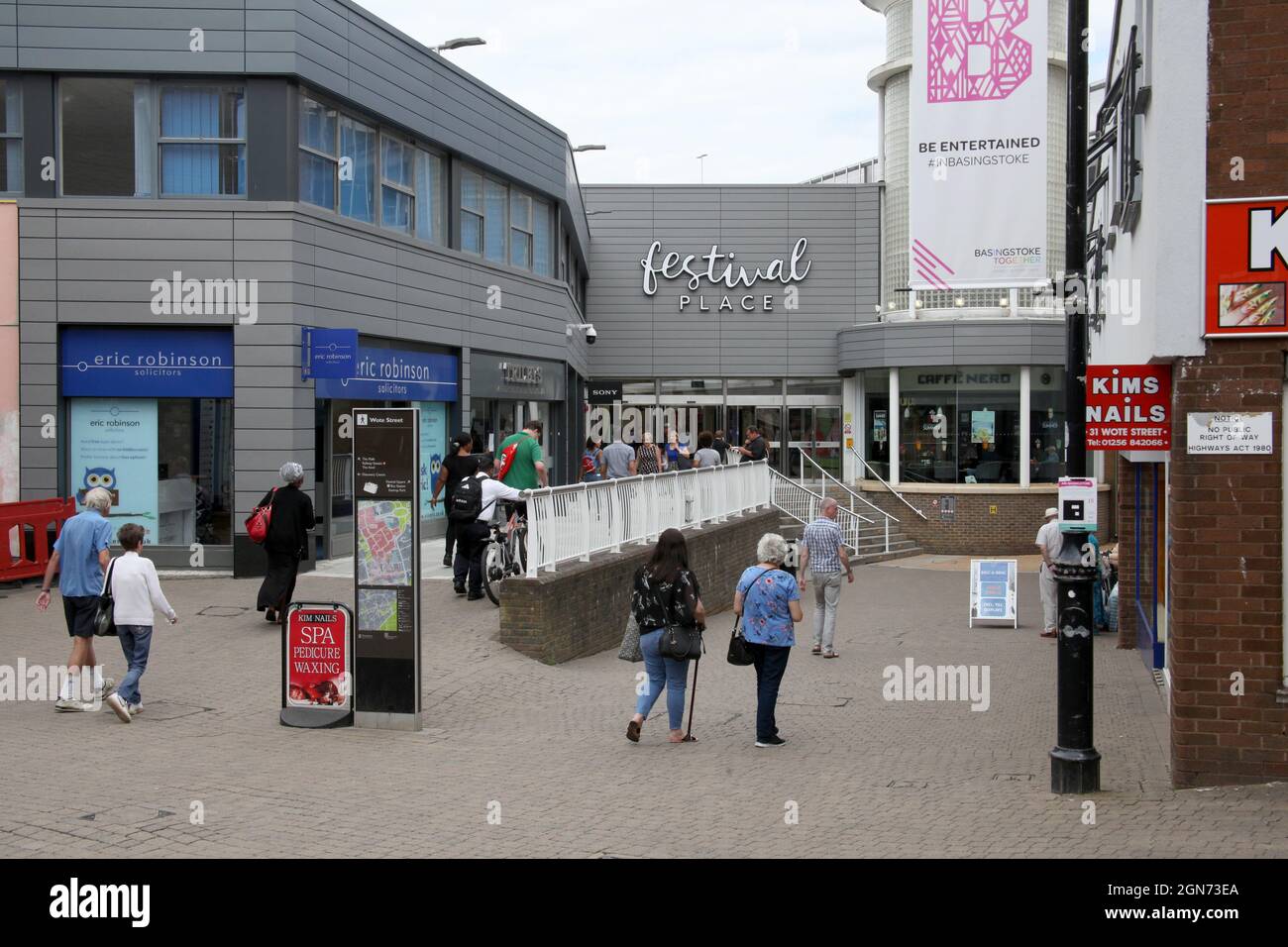 People browse the shops at Festival Place in Basingstoke, Hampshire in ...