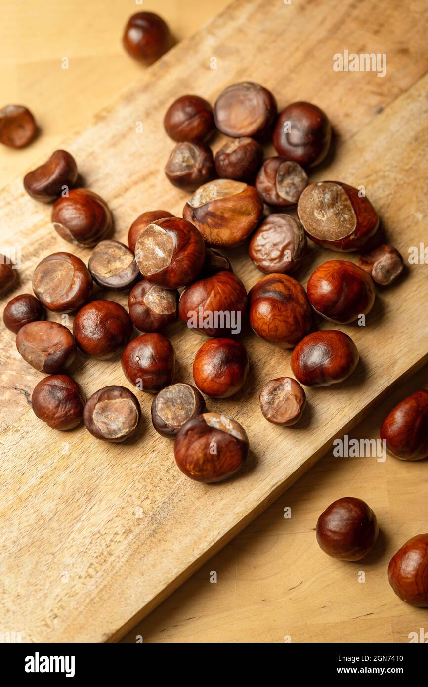 Fresh sweet edible chestnuts on wooden table Stock Photo - Alamy