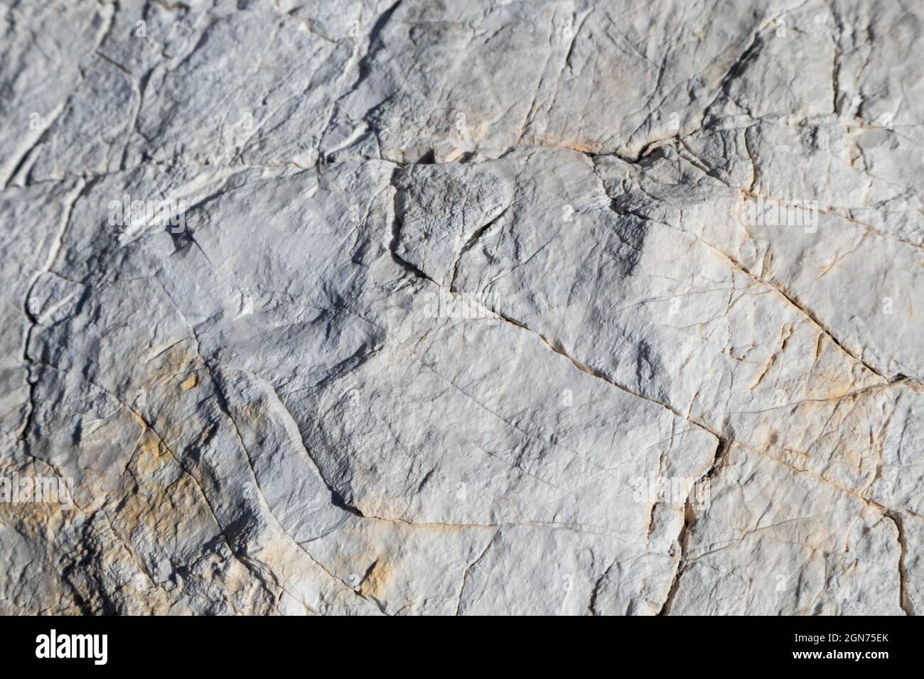 White big marble rock material with cracks close-up texture. Light ...