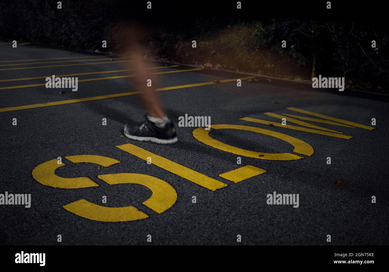 Fast running over slow sign on pavement Stock Photo - Alamy