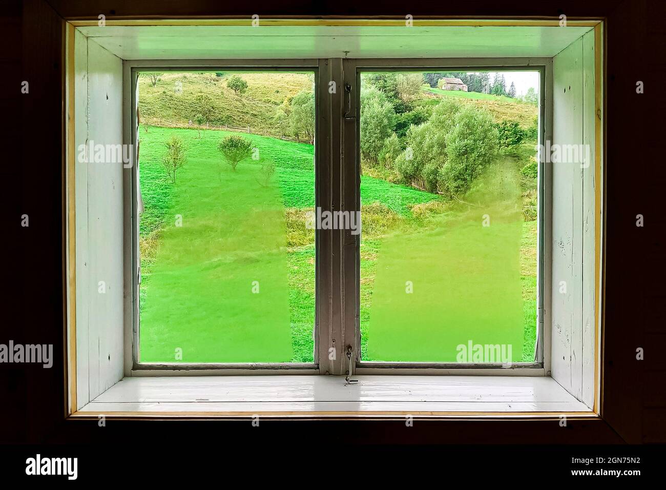 A window. view through a window to a wonderful green mountain landscape ...