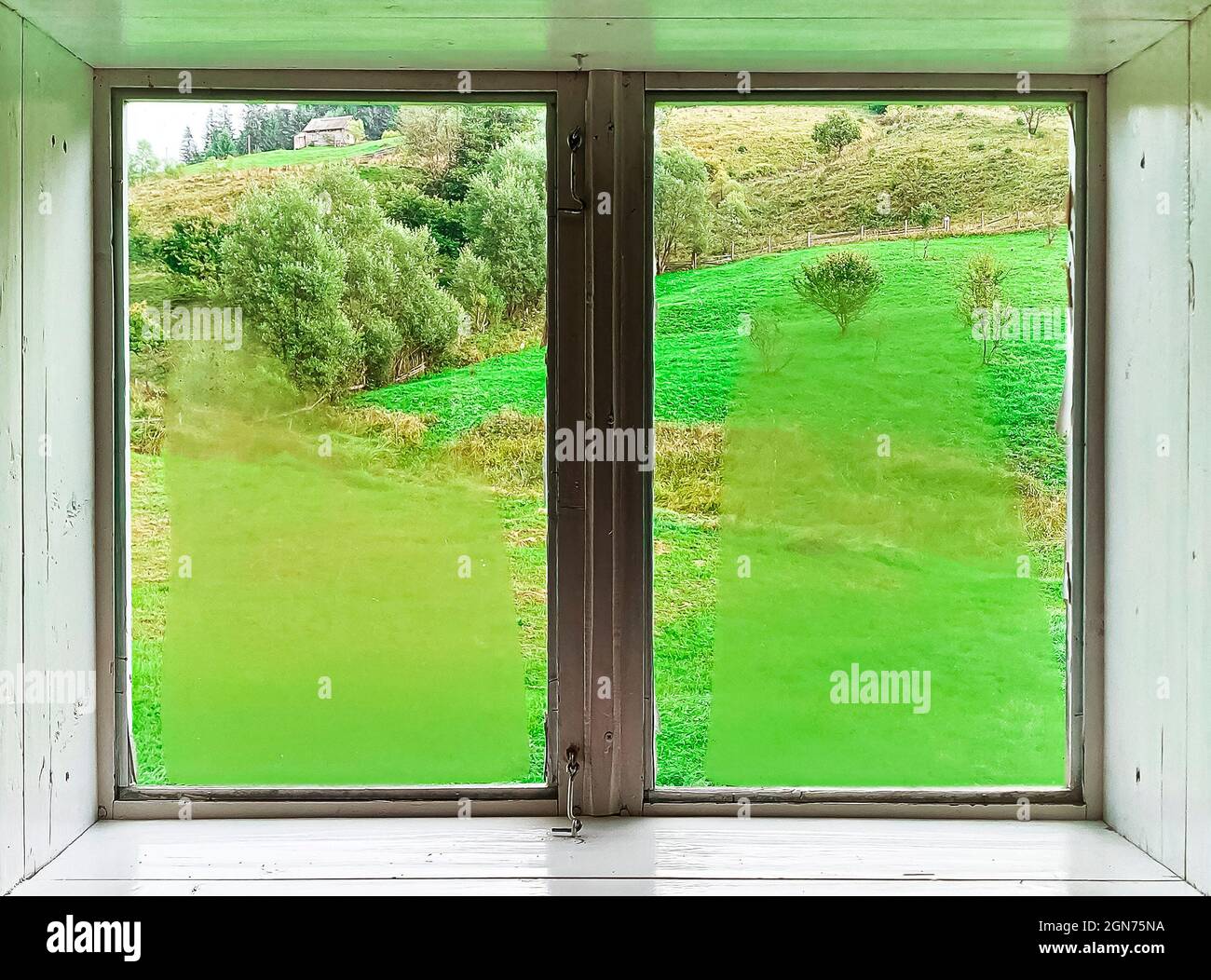 A window. view through a window to a wonderful green mountain landscape ...
