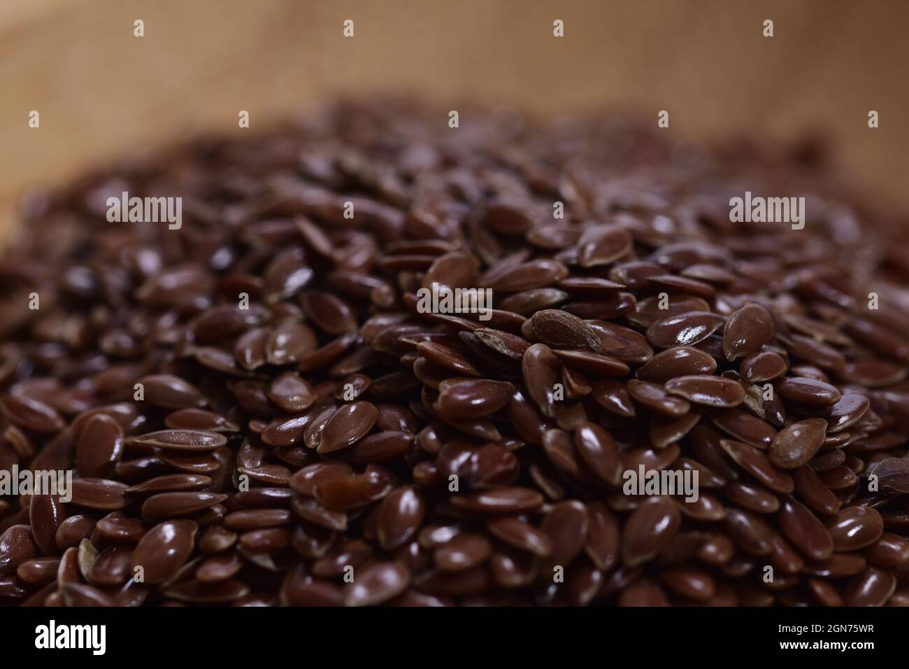 Linseed on a wooden bowl against a white background. Food Stock Photo - Alamy