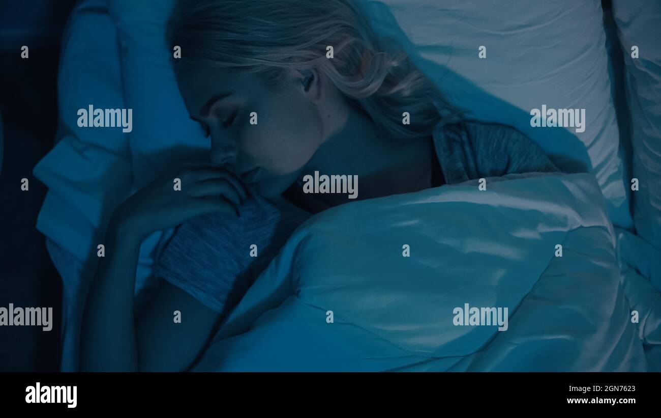 Top view of young woman sleeping on bed at night Stock Photo - Alamy