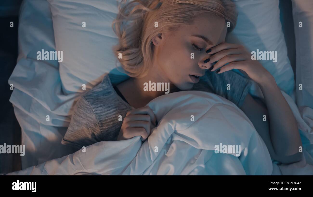 Top view of woman suffering from runny nose while sleeping on bed Stock ...