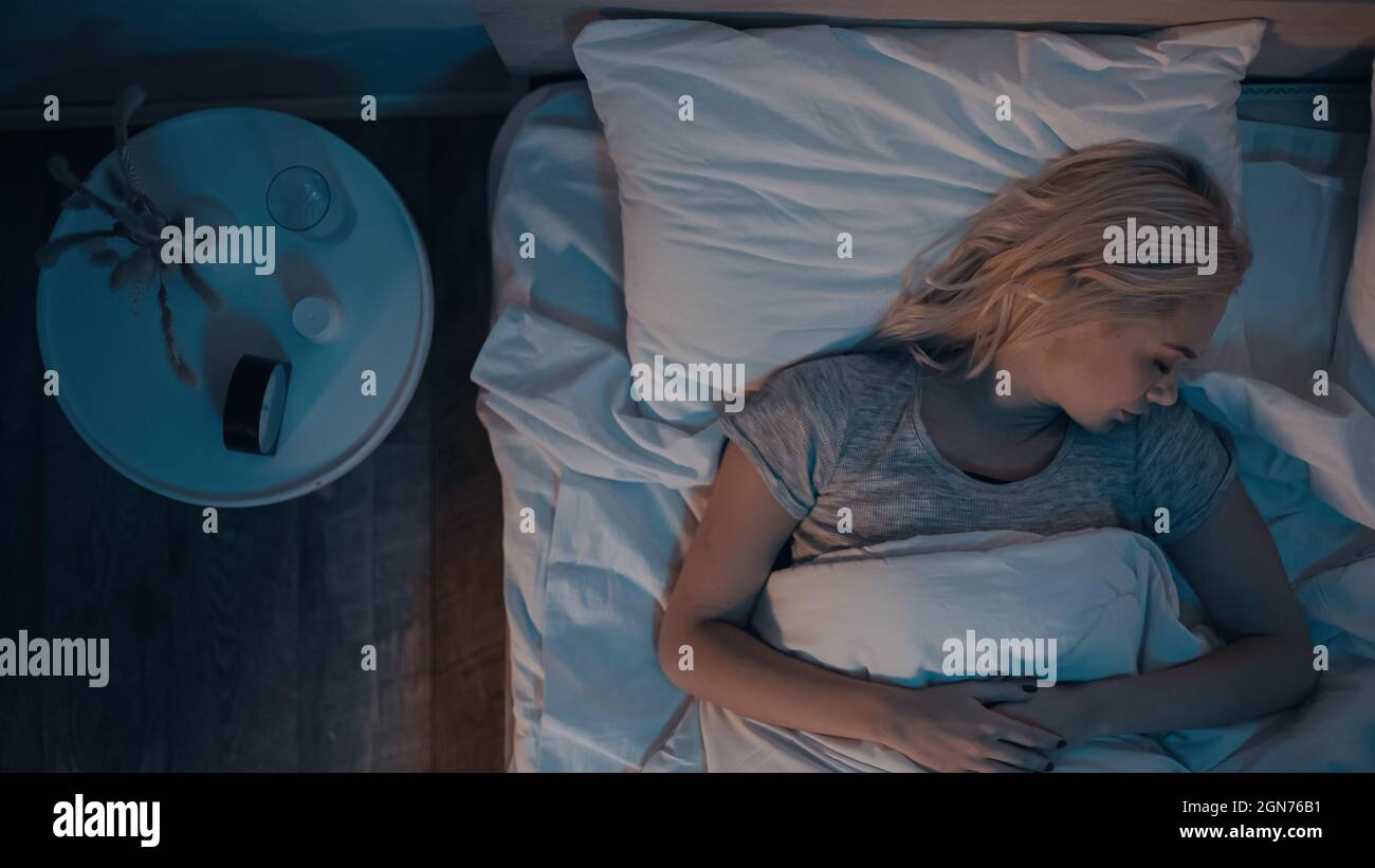 Top view of sick woman sleeping near pills and water in bedroom Stock ...