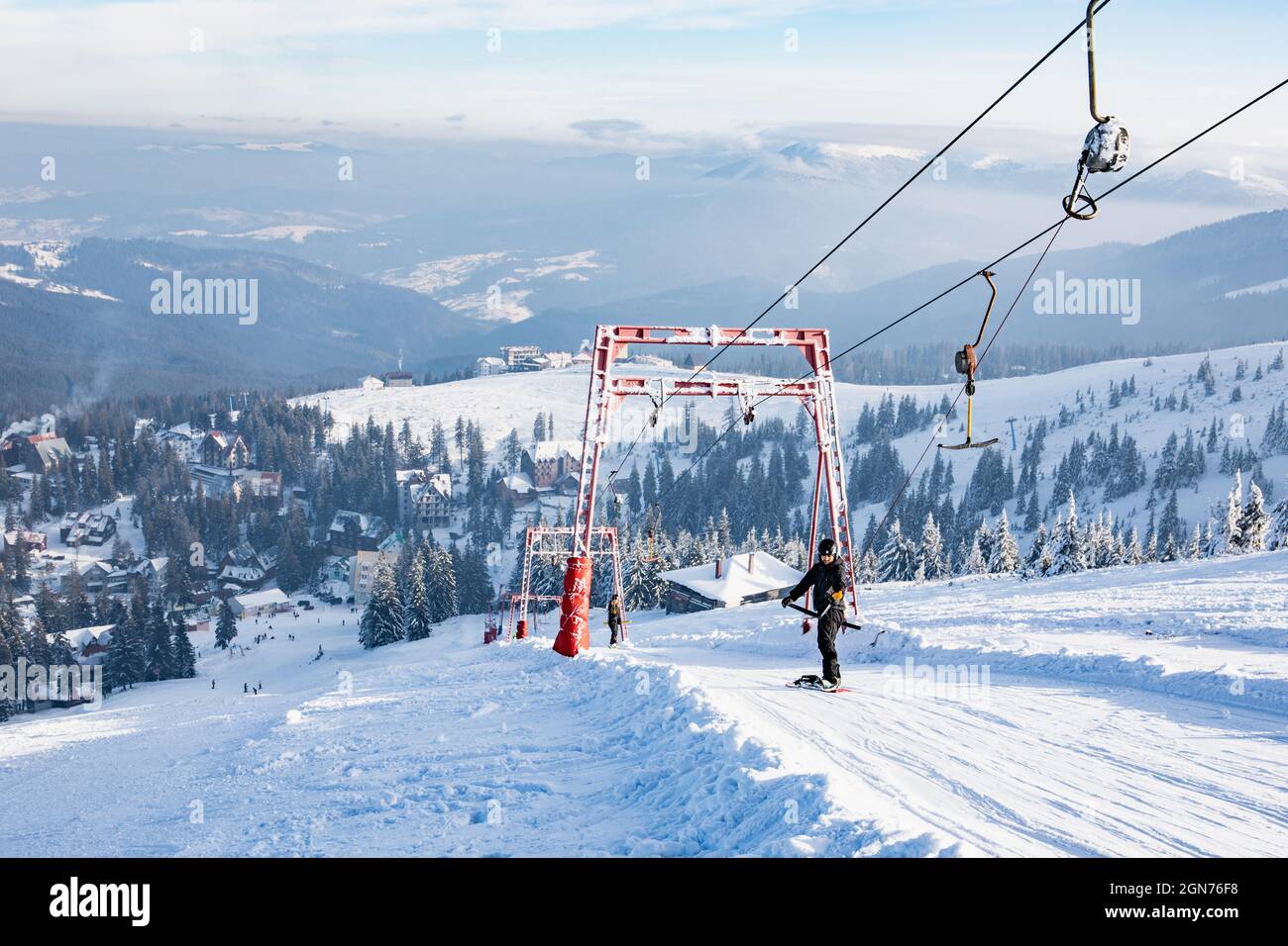Dragobrat, Ukraine - January 11, 2021: people pulling up on hill by ski ...