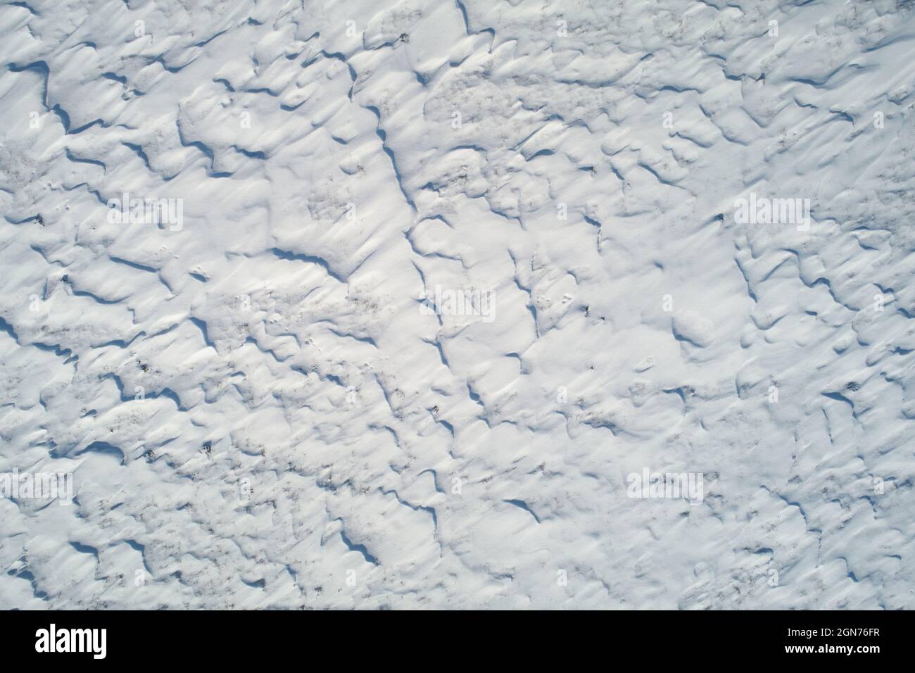 Snow field texture background aerial above drone view Stock Photo - Alamy