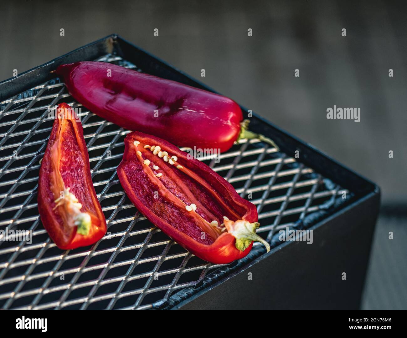 Sliced red hot pepper on grill. Close-up. Summer outdoor setting Stock ...