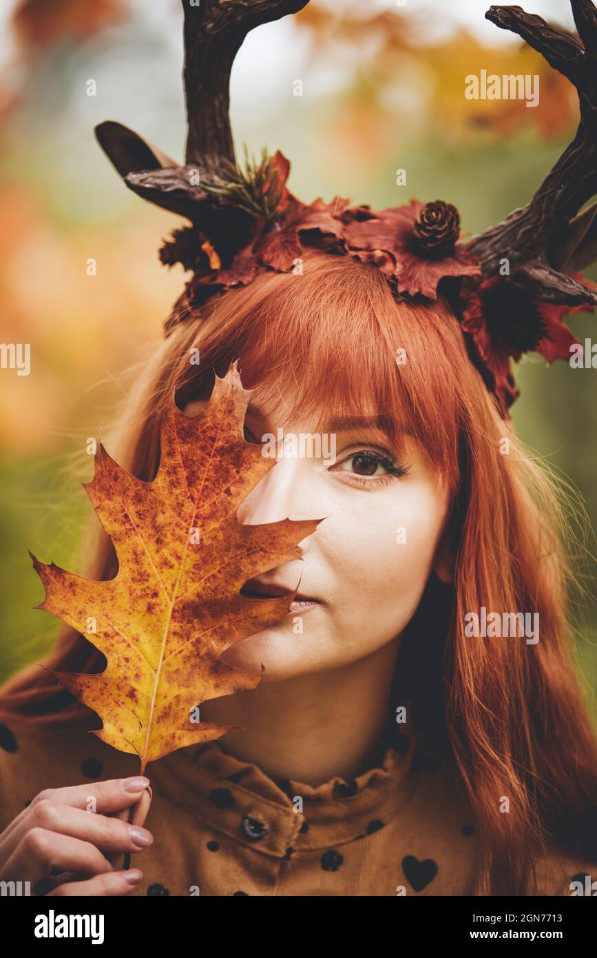 fairy woman with deer horns in autumn forest. Face painting. Beautiful ...