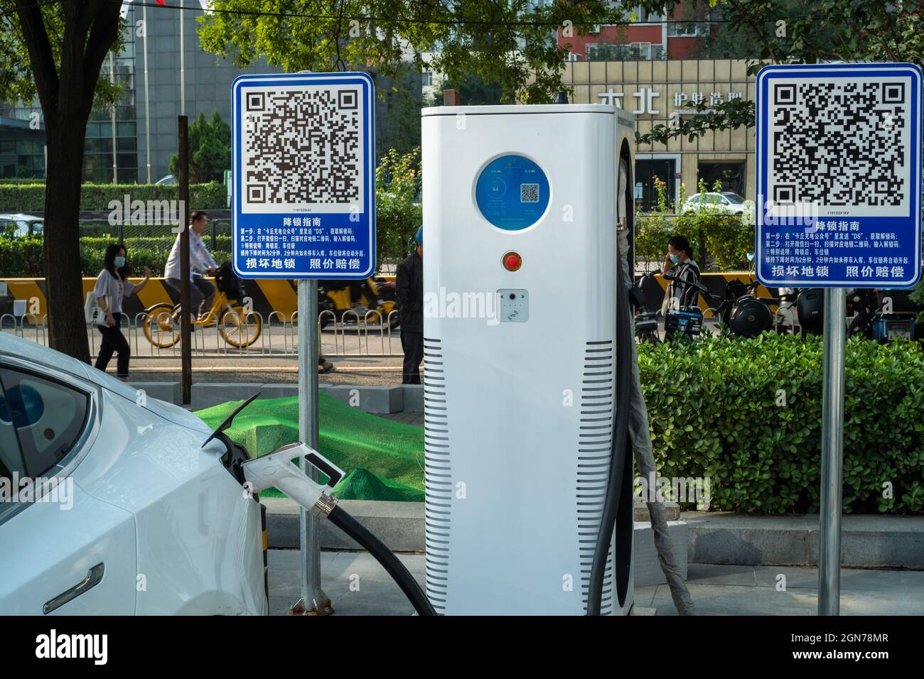 A Tesla Model3 is charging at a new charging station in Beijing, China ...