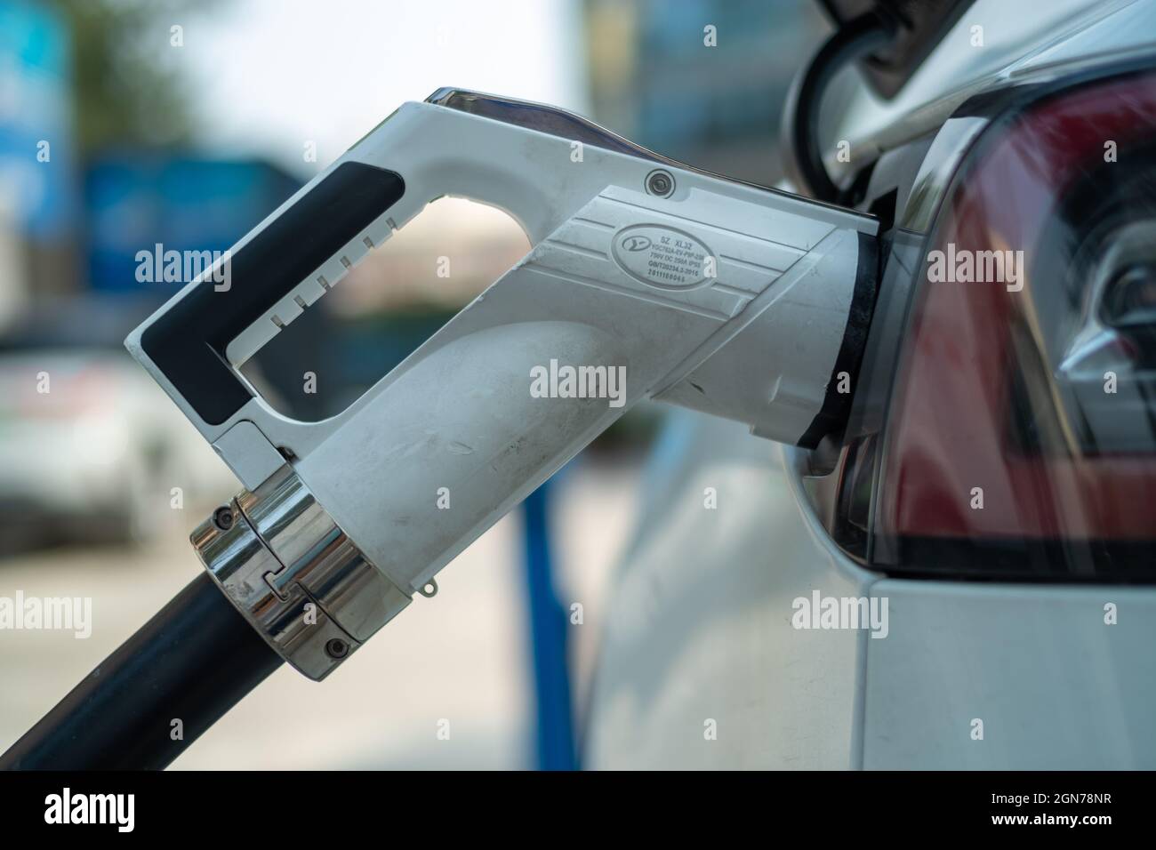 Close-up view of the charging port of a Tesla Model 3 at a charging ...