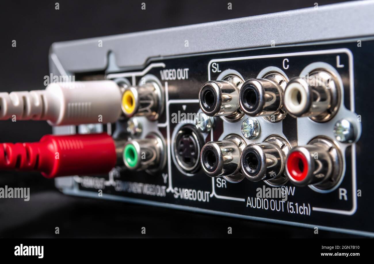 modern multimedia and audio equipment with attached cables on black ...