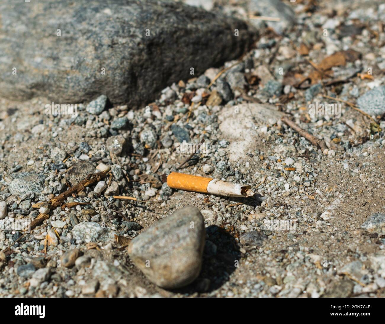 High angle shot of a cigarette thrown away on the ground Stock Photo ...