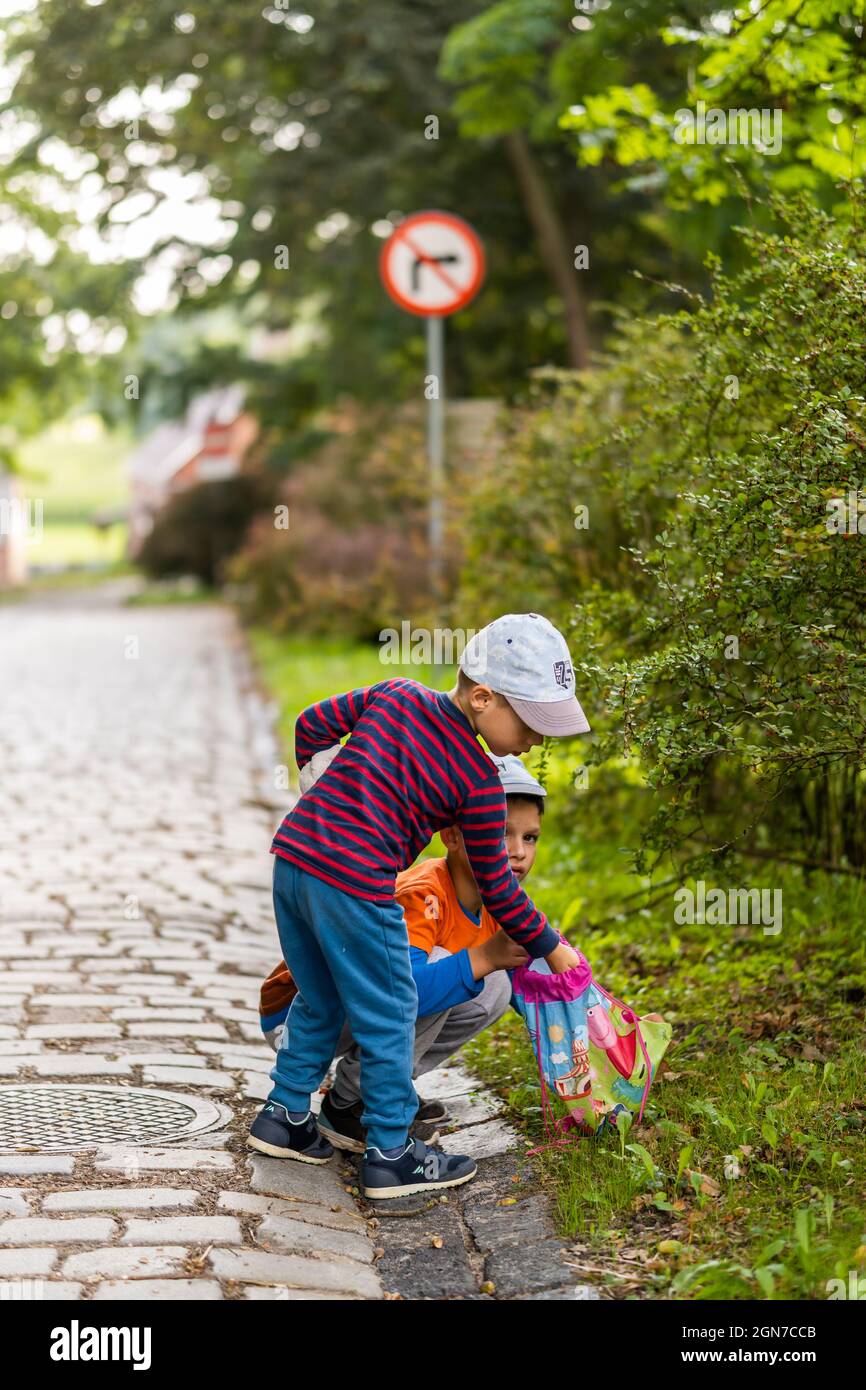 ROGALIN, POLAND - Sep 04, 2021: The Two young boys collecting things in ...
