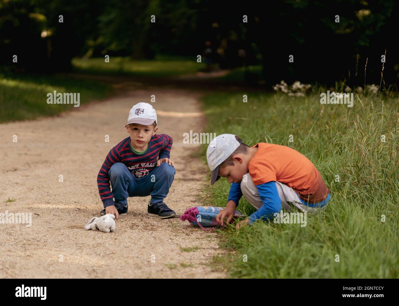 Boy looking at something on ground hi-res stock photography and images ...