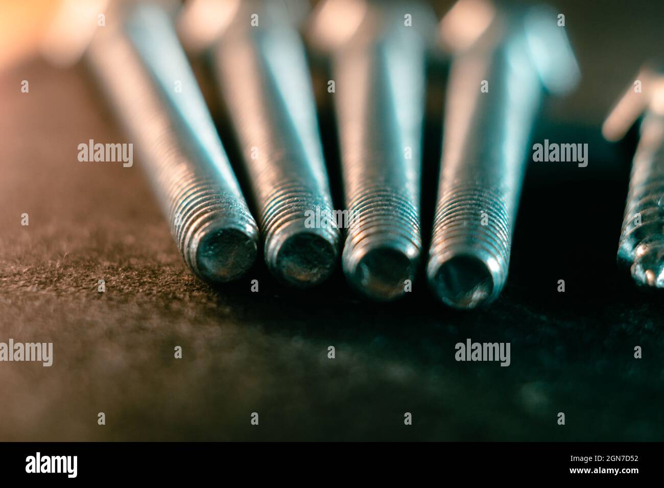 Pile of screws on a dark background Stock Photo - Alamy