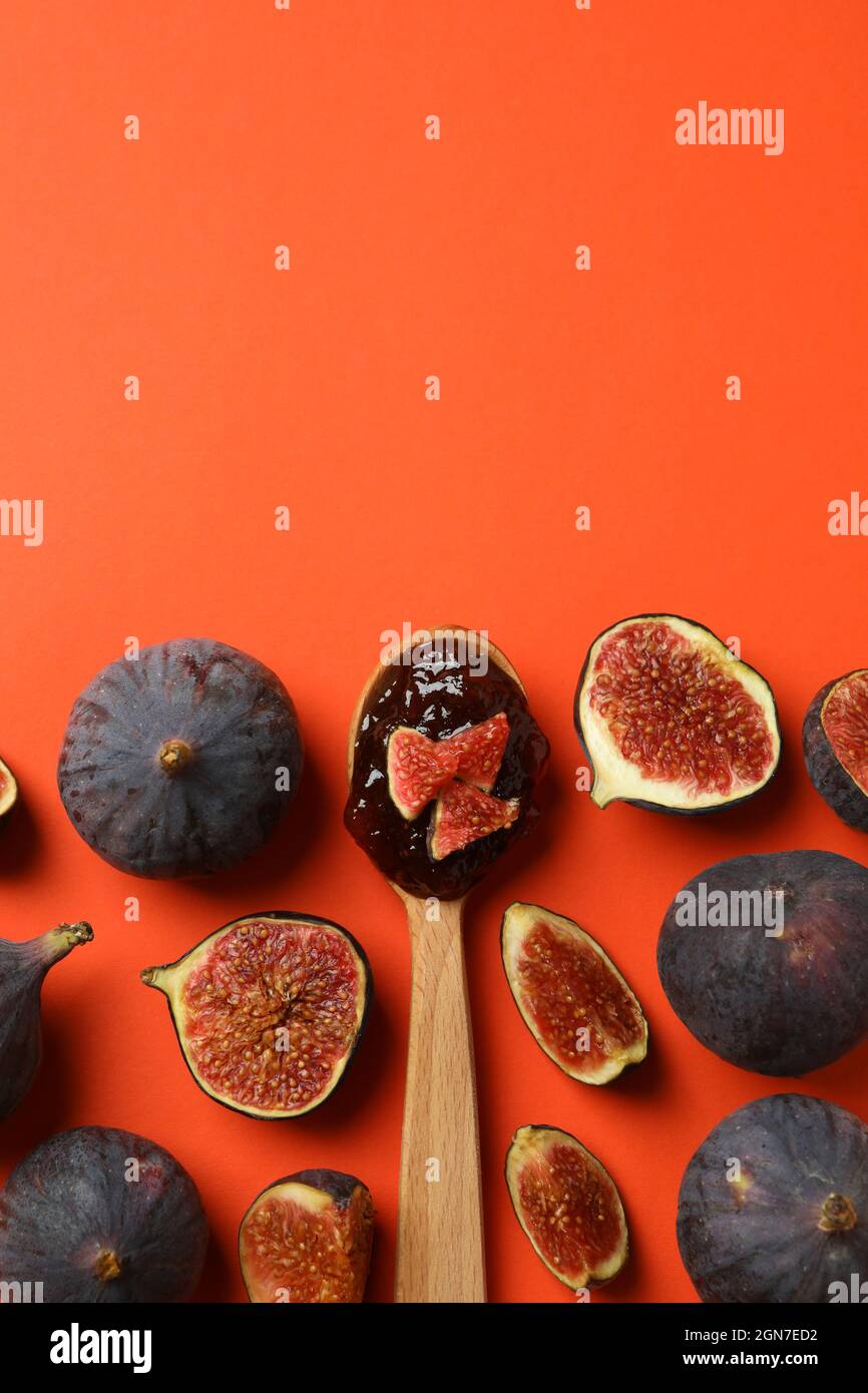 Spoon with fig jam and ingredients on orange background Stock Photo - Alamy