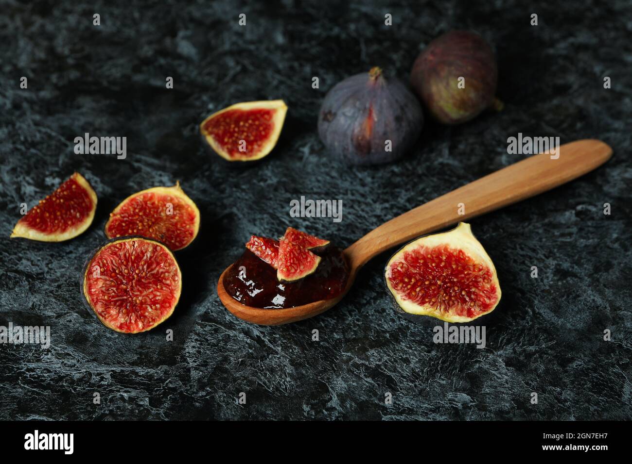Spoon with fig jam and ingredients on black smokey background Stock ...