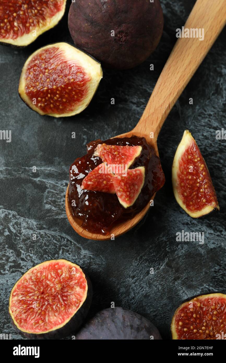 Spoon with fig jam and ingredients on black smokey background Stock ...