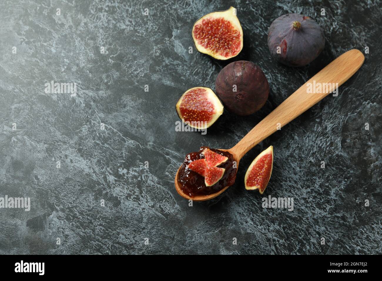 Spoon with fig jam and ingredients on black smokey background Stock ...