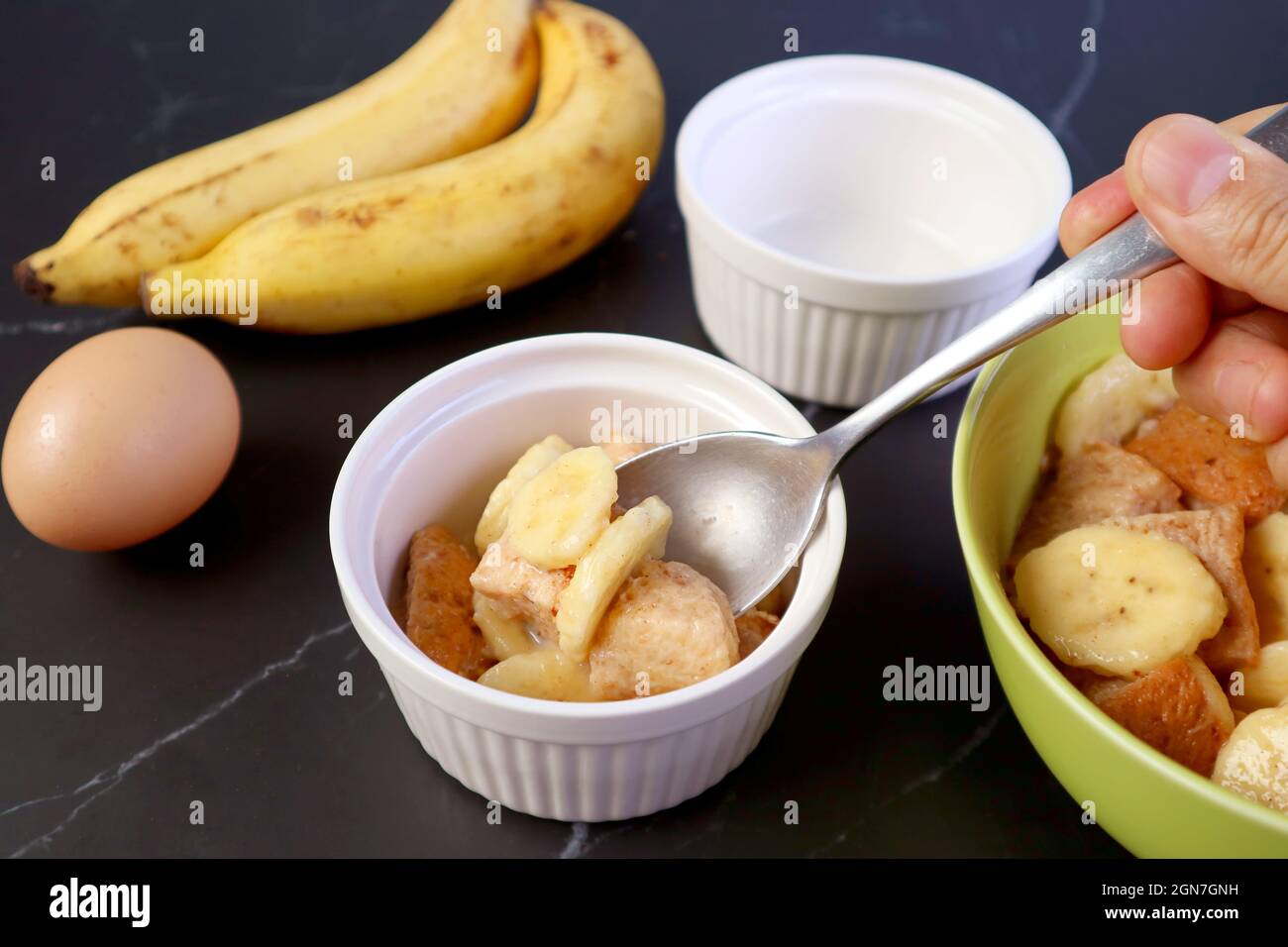 Hand Holding Spoon Putting the Mixture into a Bowl for Baking Banana ...