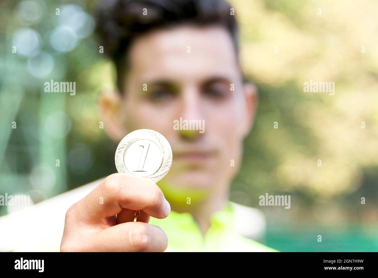 running man showing his medal outdoor after the race Stock Photo - Alamy