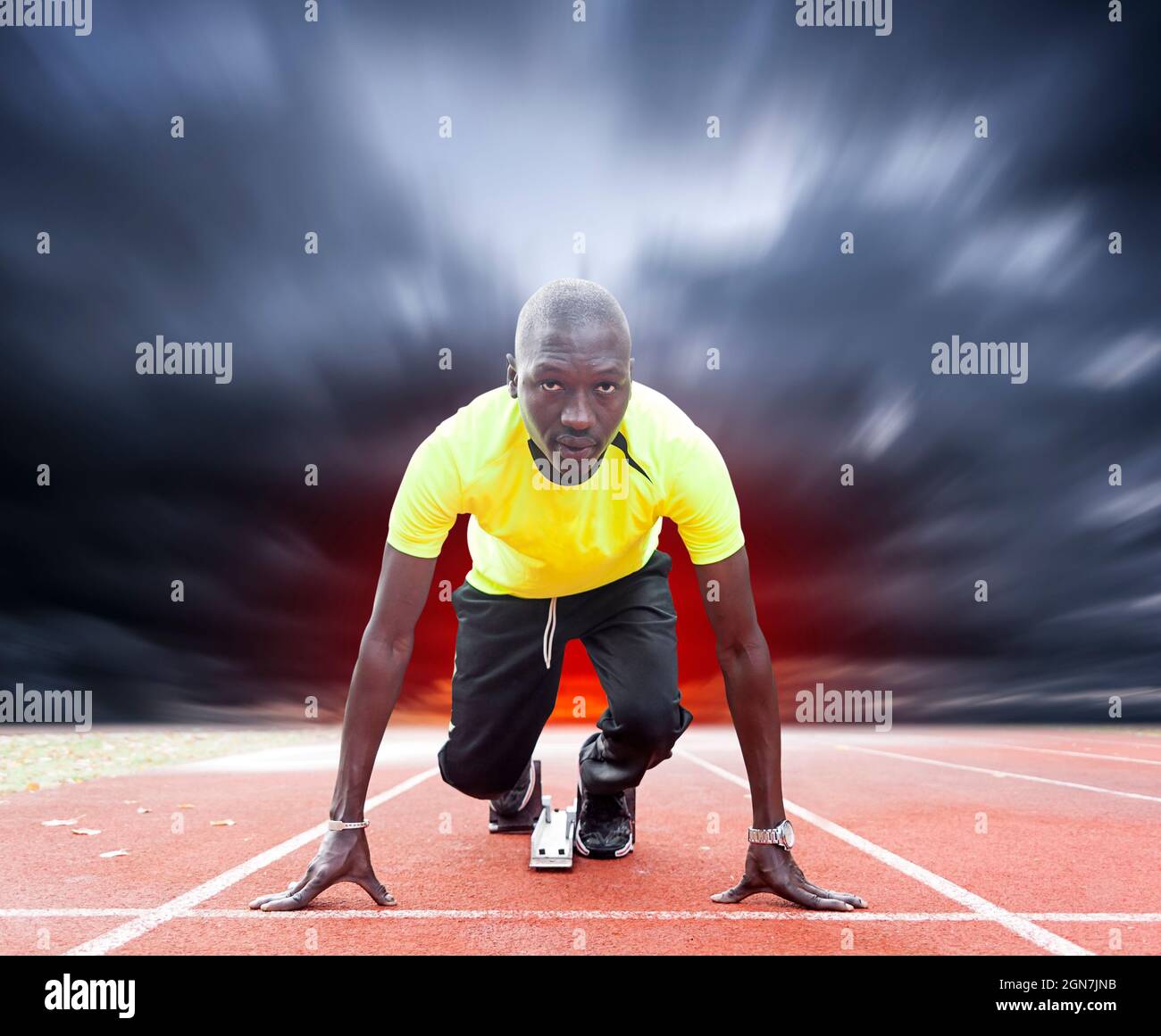 african american athlete sprinter on the starting blocks under stormy ...