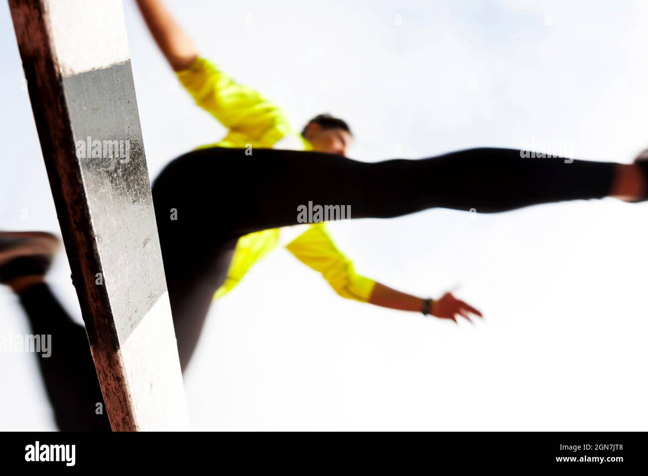 young athlete jumping during obstacle race. low view Stock Photo - Alamy