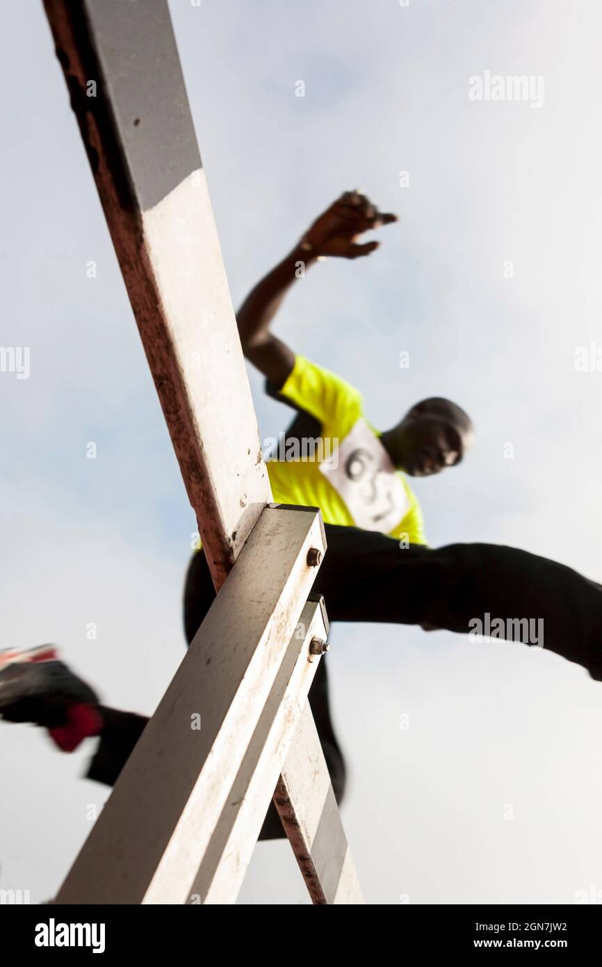 african american athlete jumping during obstacle race. low view Stock ...