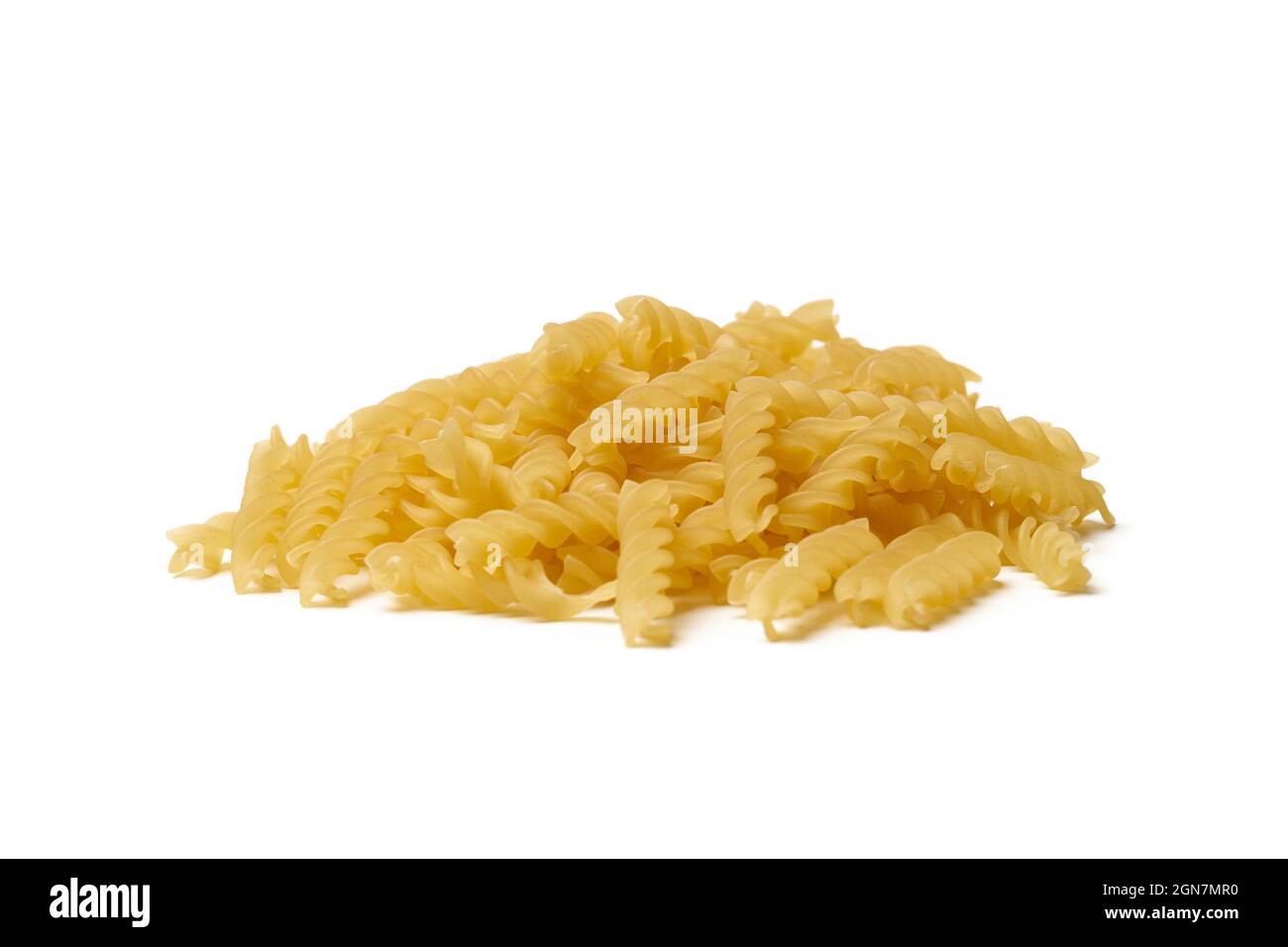 Close-up of a heap of raw fusilli pasta isolated on white background ...