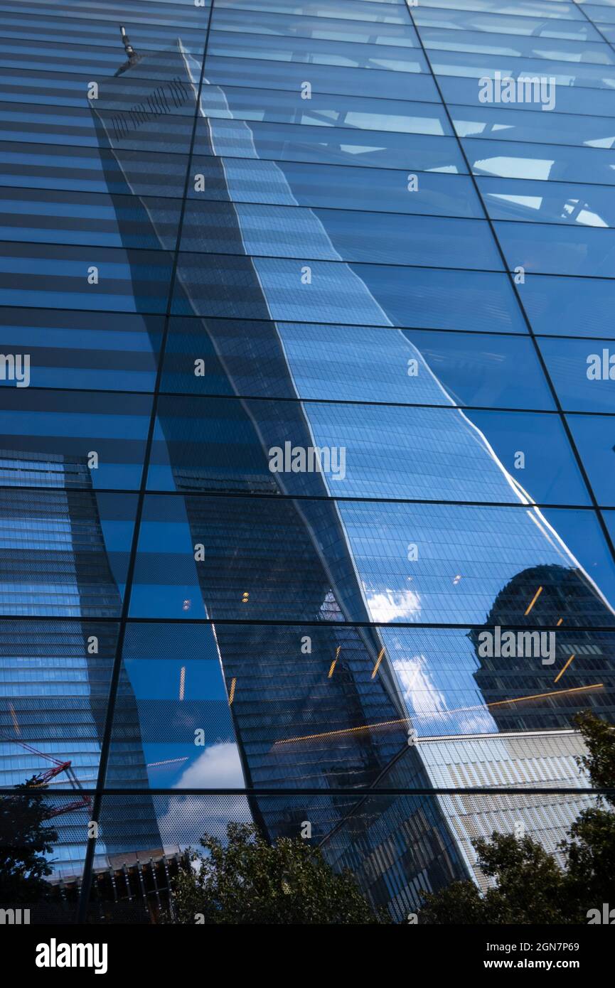 New World trade center reflected in a new glass building Manhattan NYC ...