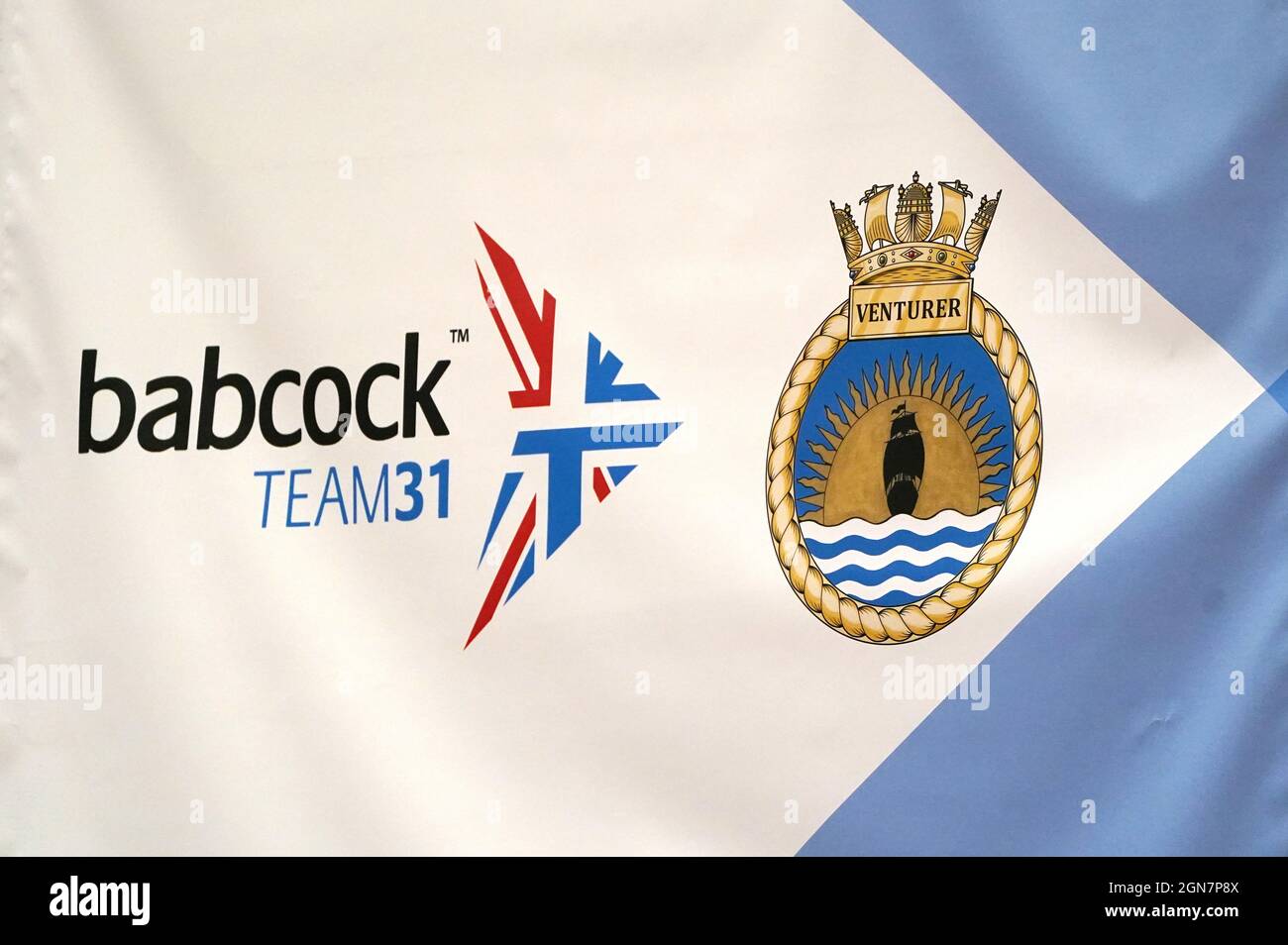 A banner displaying the ships crest for HMS Venturer is shown at a ...