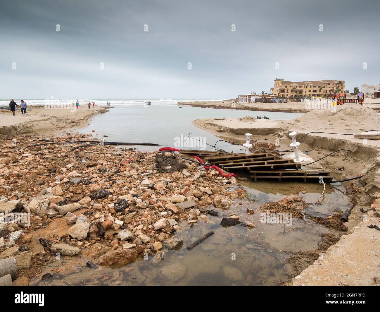 Storm damage caused by floodwater flowing into the sea at La Zenia ...
