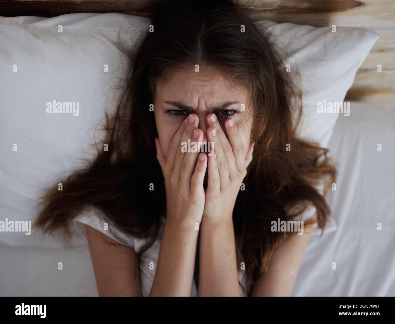 crying woman lying in bed temperature upset Stock Photo - Alamy