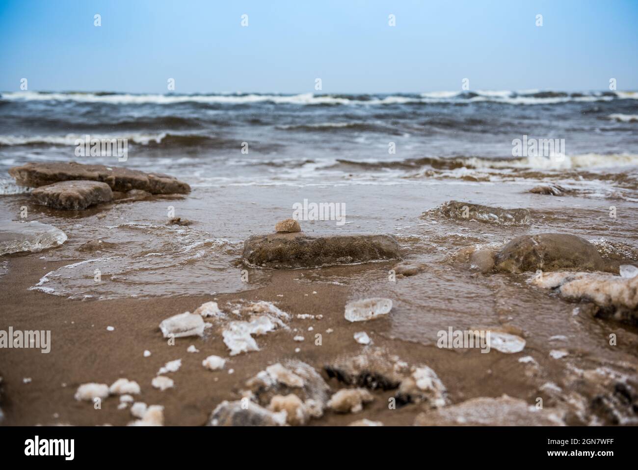 Winter Baltic Sea beach is snowy and there are big waves in the sea ...