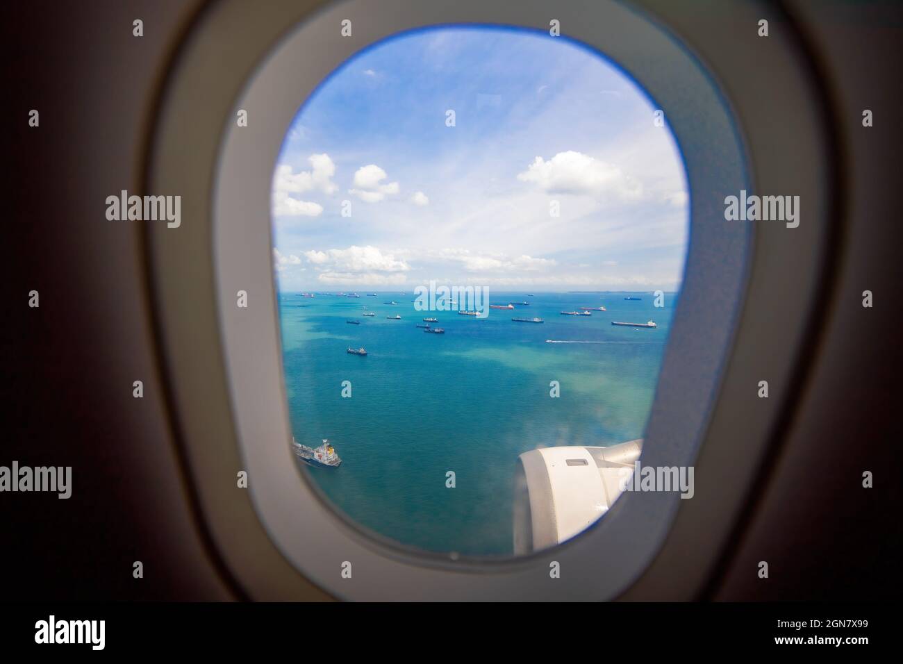 beautiful view from the window of the plane to the sea and cargo ships ...
