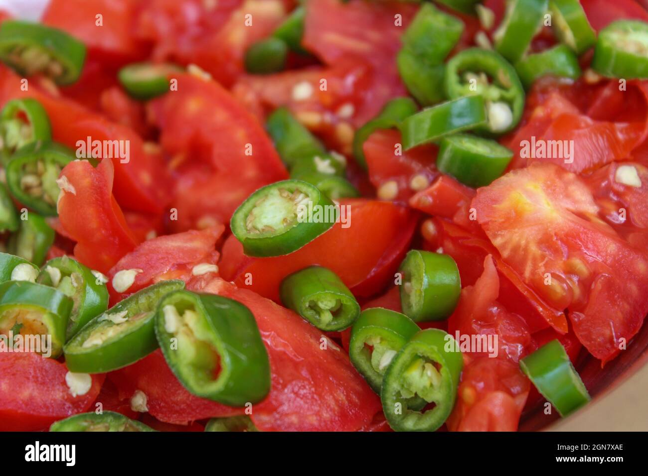 mixed green chilli and tomato cut Stock Photo - Alamy