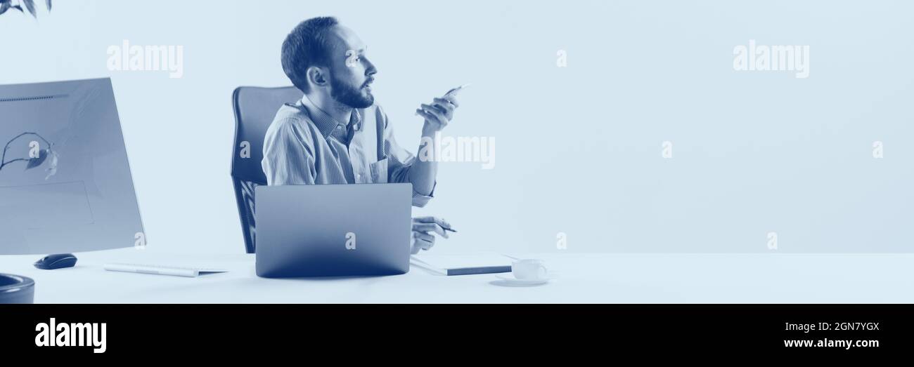 Side view of employee making business call in the office. Career ...
