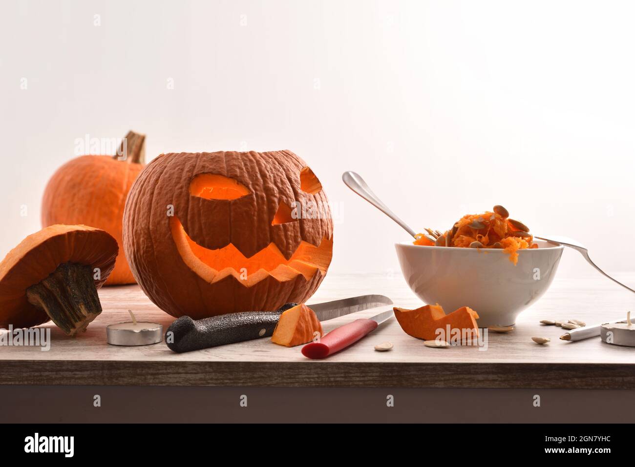 Freshly carved hallowen squash on the table isolated white. Front view ...