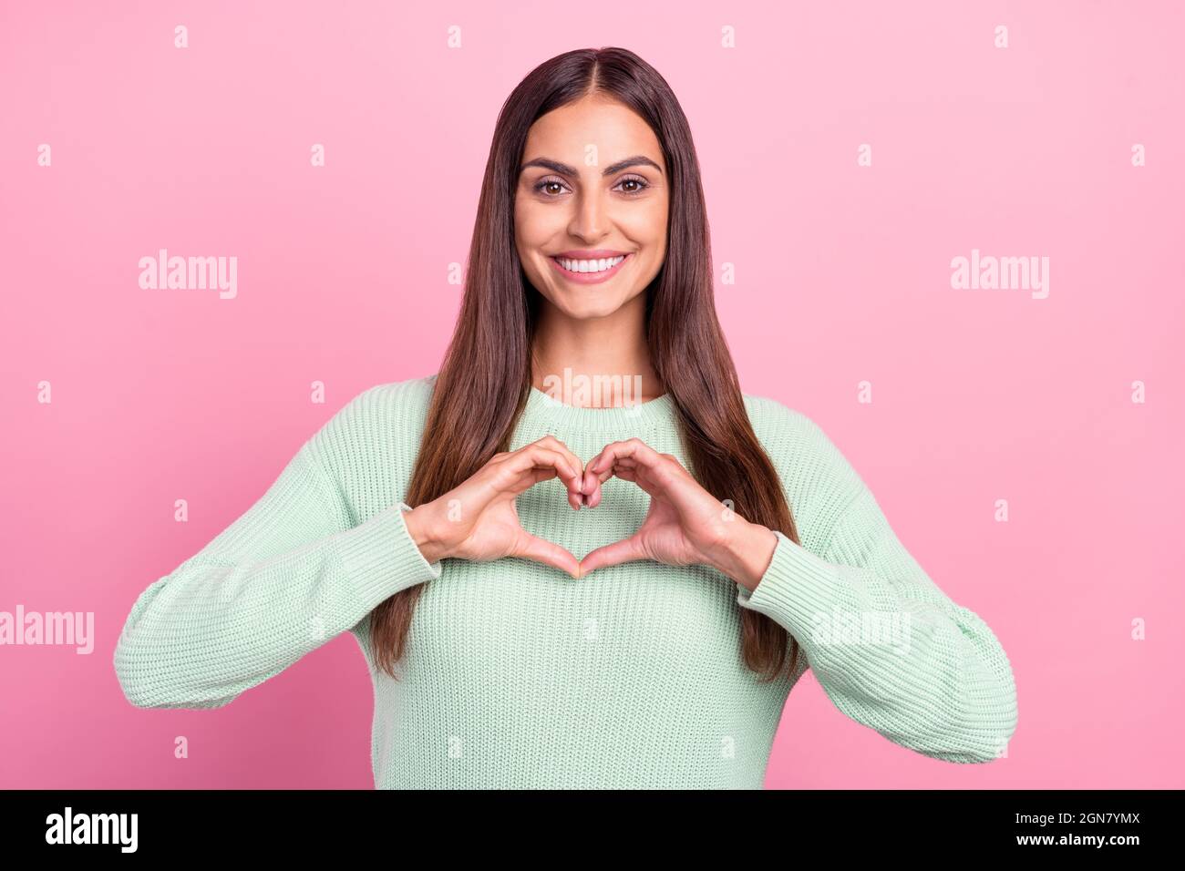 Photo of cute young brunette lady hands heart wear green pullover ...