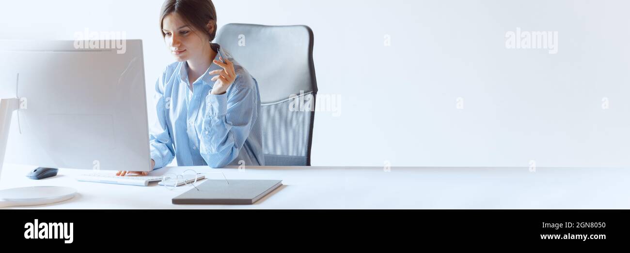 Female employee working with computer, creating and processing ideas in ...