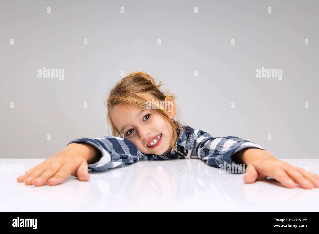 Portrait of beautiful little girl looking at camera, making faces ...