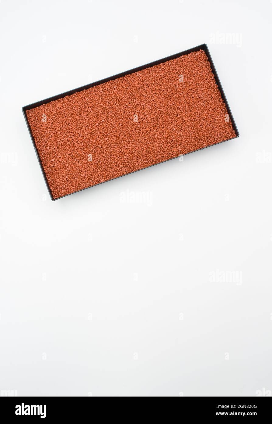decorative orange colored sand in a metal box Stock Photo - Alamy