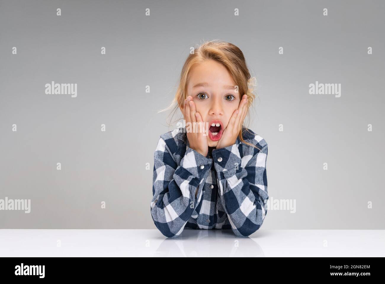 Portrait of beautiful little girl looking suprised, shocked isolated on ...